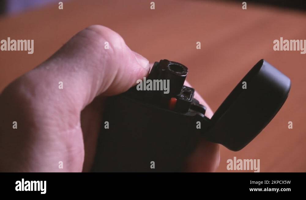 Hand holding gas lighter, thumb light up blue fire Stock Video Footage ...