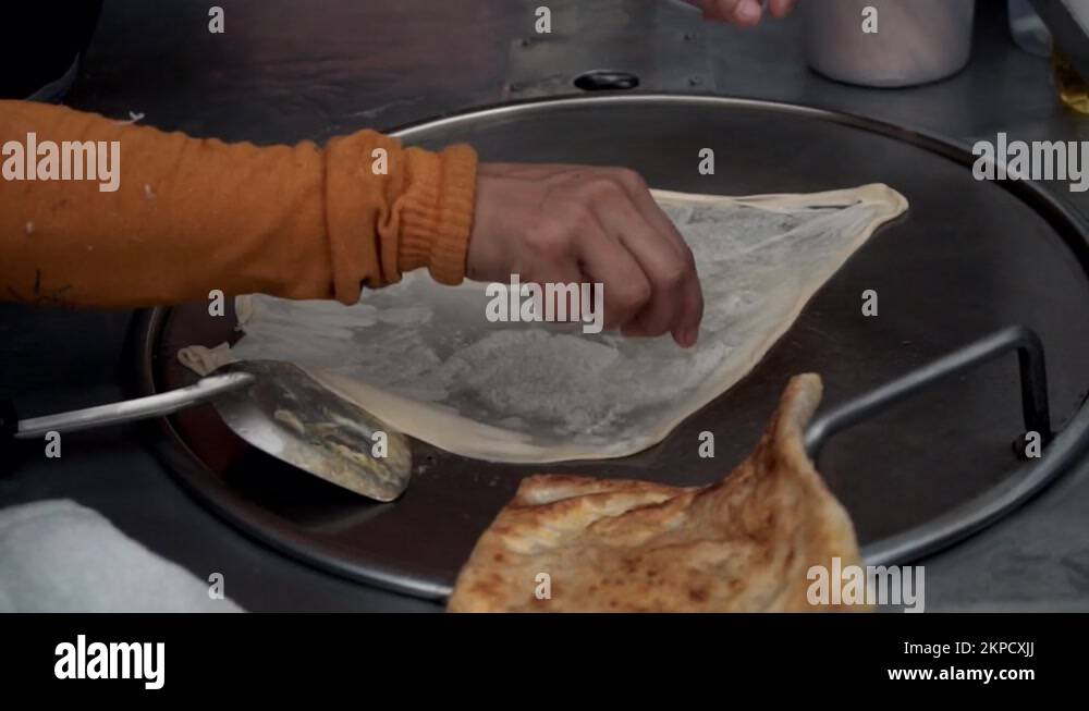 Making traditional Indian food called 'Roti Canai', slow motion Stock ...