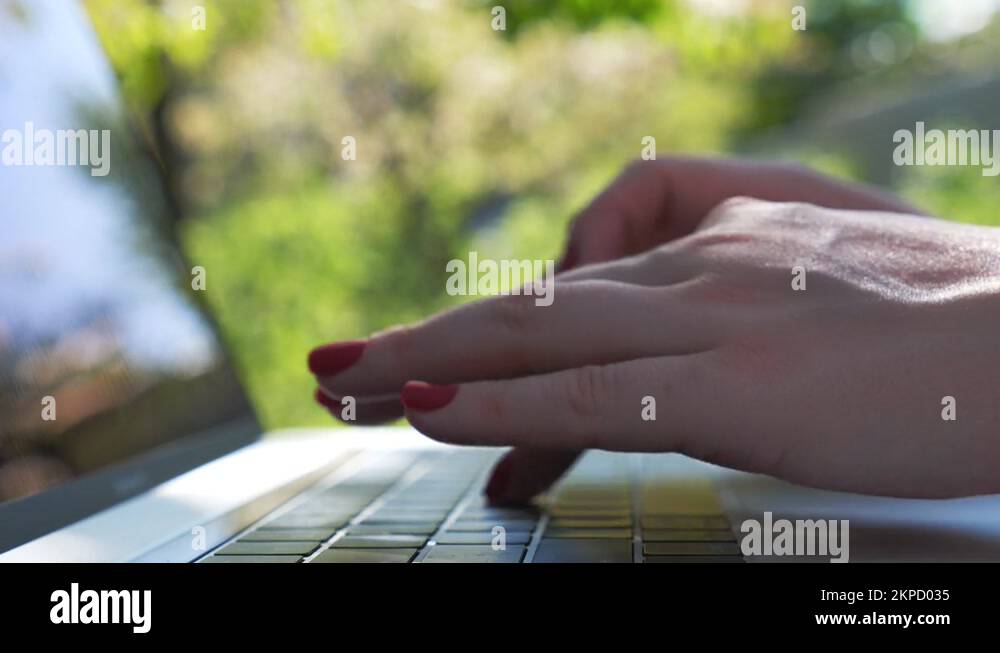 Female hands typing some text on keyboard of laptop. Woman working at ...