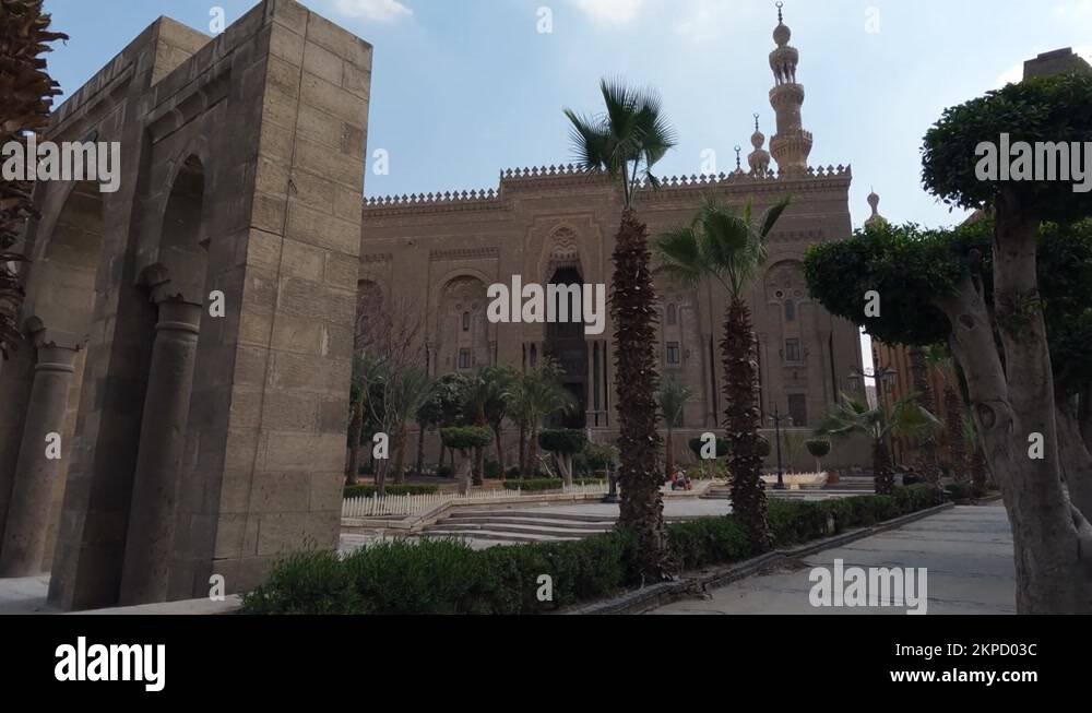 Exterior of mosque madrasa of Sultan Hassan with palm trees and ...