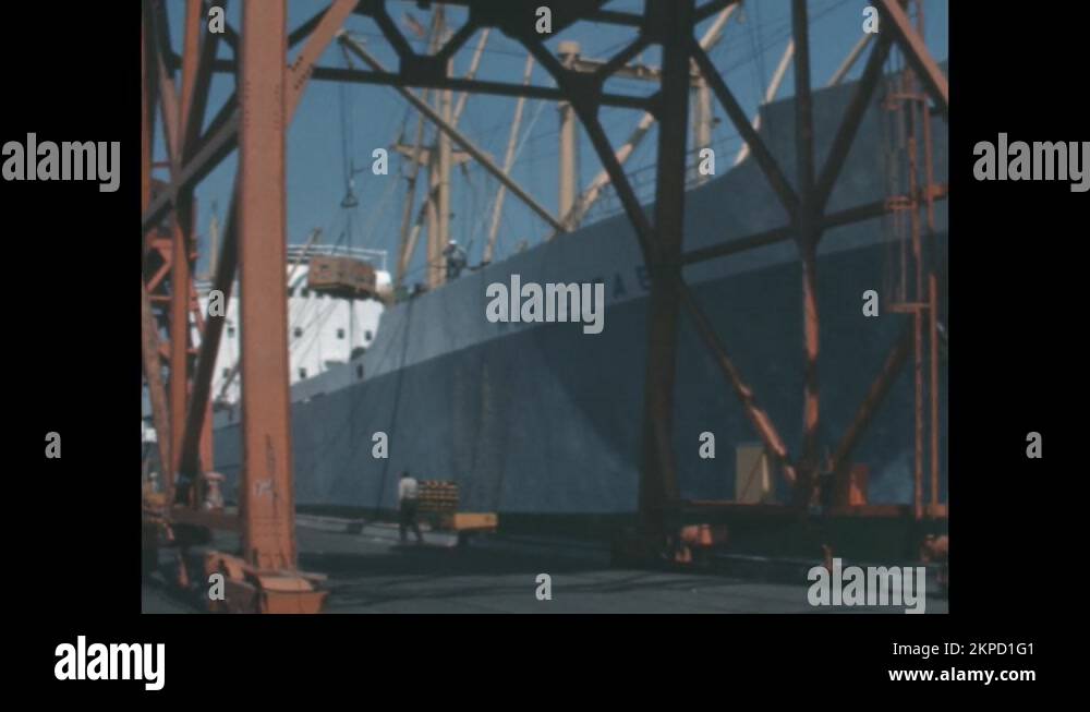 1960s: Box is loaded from cargo ship to dock. Cargo boat Marietta is ...