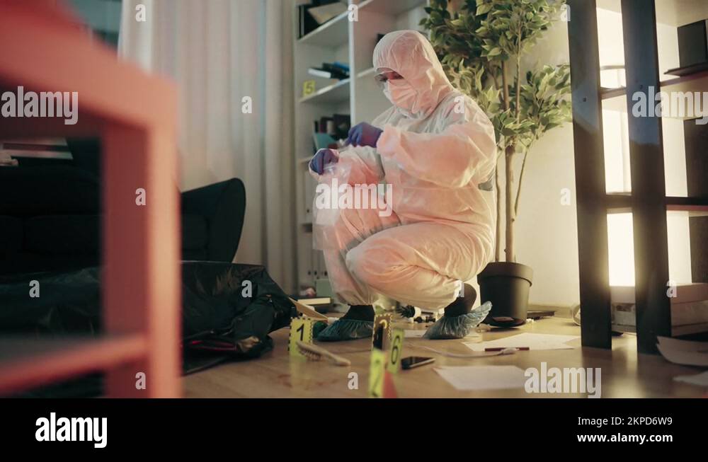 Crime lab worker collecting evidence in trashed flat, documenting crime ...