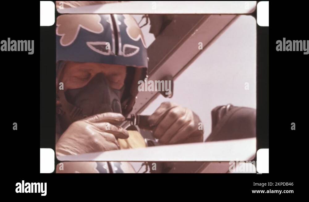 1960s: Pilot in cockpit of fighter jet puts on helmet, oxygen mask and ...