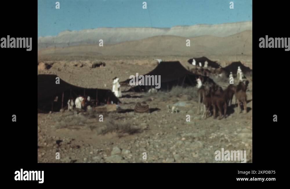 100 BC: Scrubby desert area, tents, people, camels. Man wears toga ...