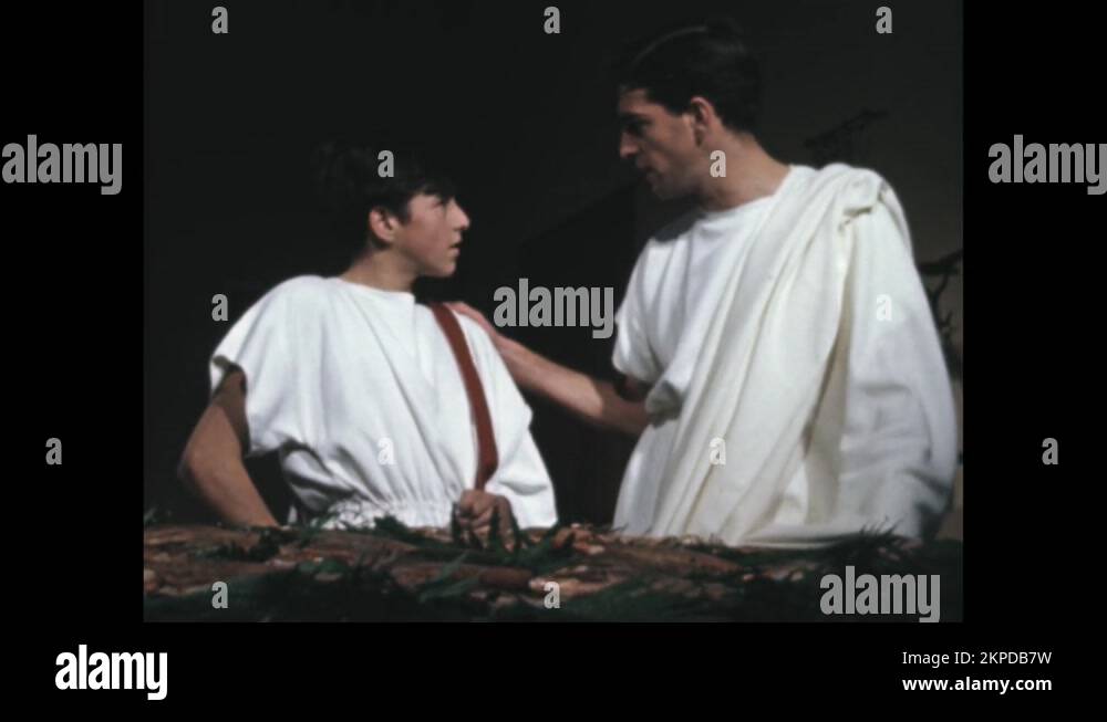 100 BC: Market, man stands behind counter, wears toga, holds fish ...