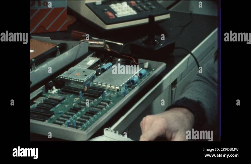 1980s: hand pushes switch. Man works at desk with circuit. Flow of ...
