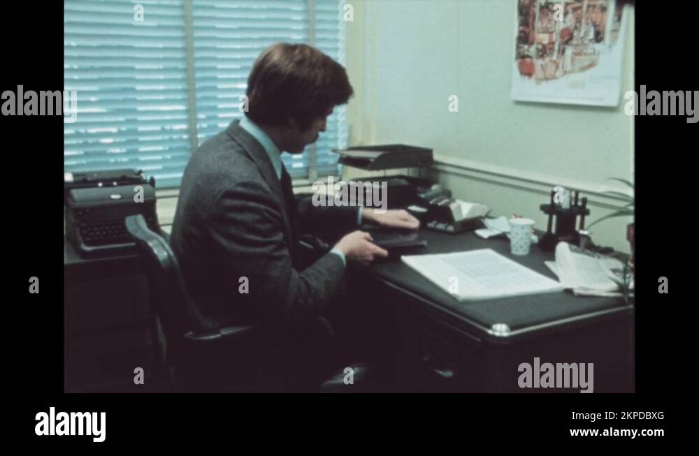 1970s: man works at office desk in 1970s. Man with 1970s moustache and ...