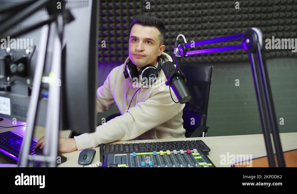 a male radio dj in between broadcasts in a radio studio Stock Video ...