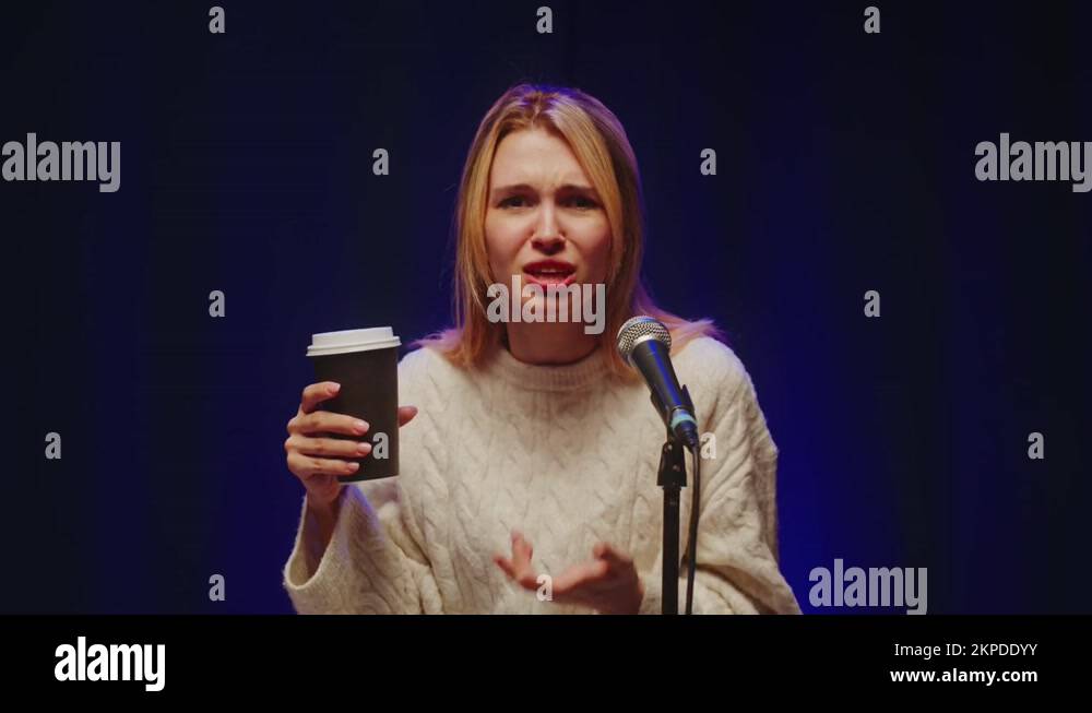Stand-up cafe, woman comedy concert. Woman telling jokes on stage ...
