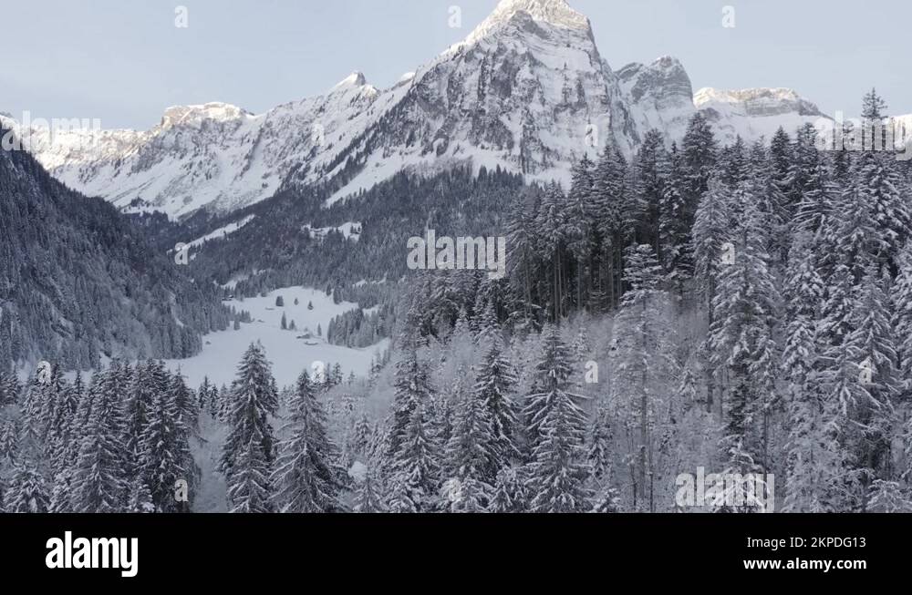 Wonderful winter landscape revealing a high rugged mountain with a ...
