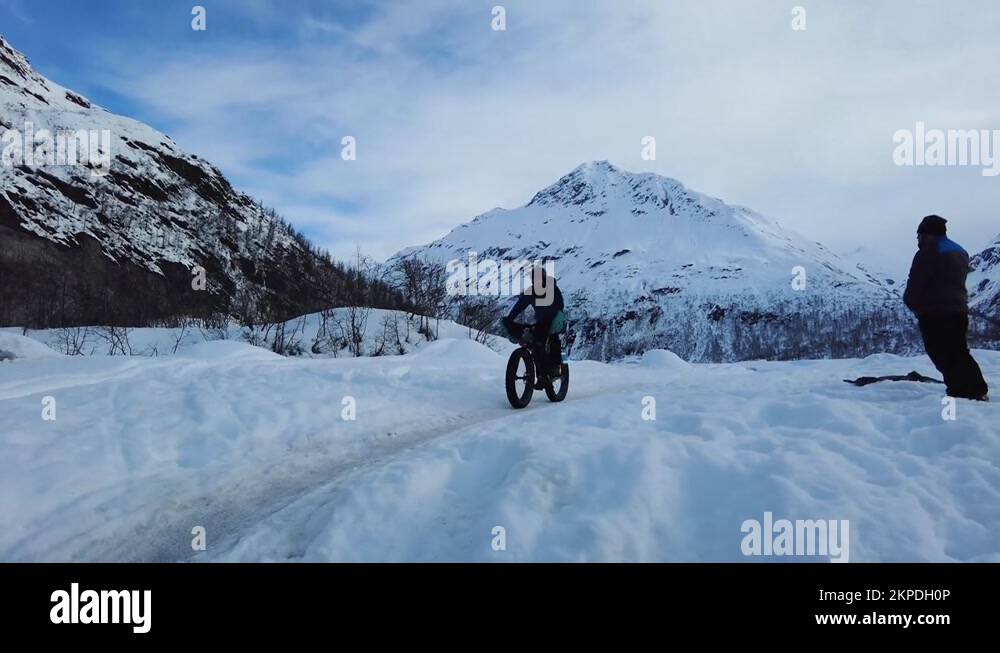 People cheering as a Fat Tire Bike Bash Participant crosses the finish ...