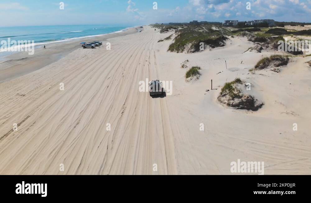 Drone following black suv on Outer Banks Corolla 4x4 beach Stock Video ...