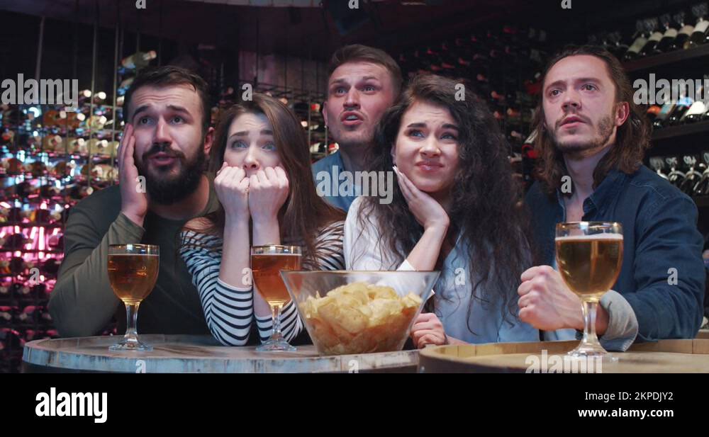 Upset company of Caucasian friends getting sad of favorite football ...