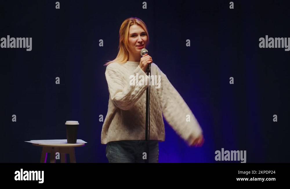 Stand-up cafe, woman comedy concert. Woman telling jokes on stage ...