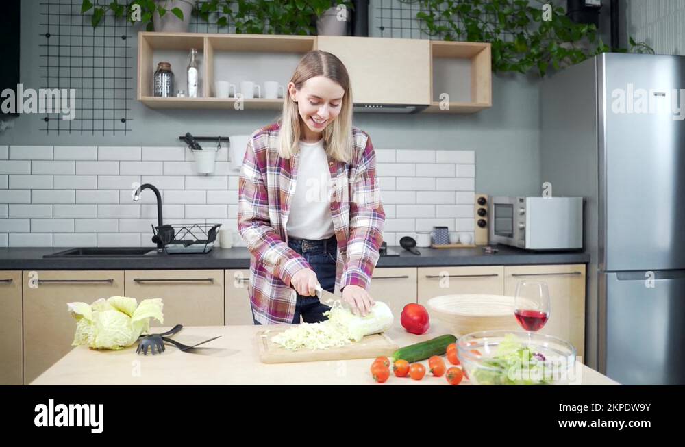 young woman chef coach tells a recipe how to cook healthy food. Looking ...