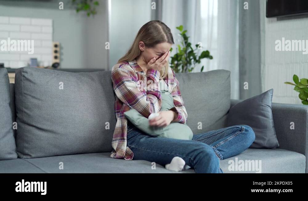 frustrated sad girl crying at home on the couch. young depressed woman ...