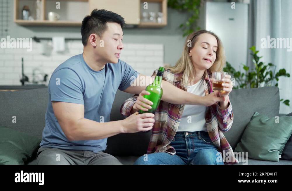 Alcoholic woman drinking strong alcohol at home, husband frustrated and ...