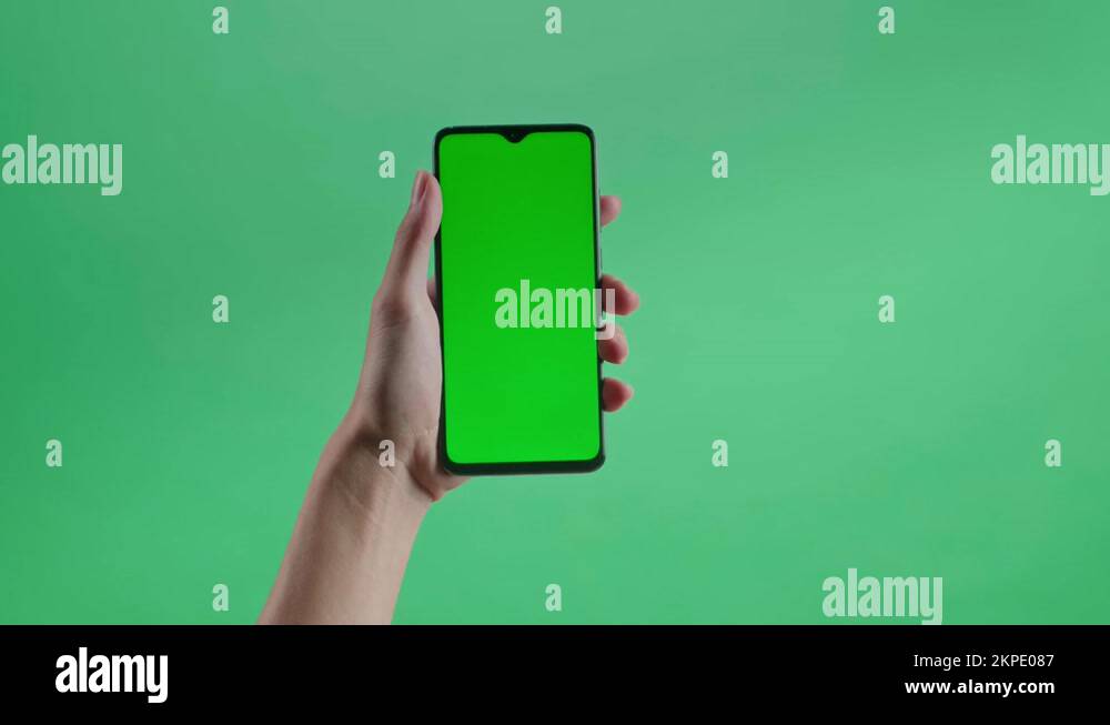 A Hand Holding Green Screen Smartphone On Green Screen Background Stock ...