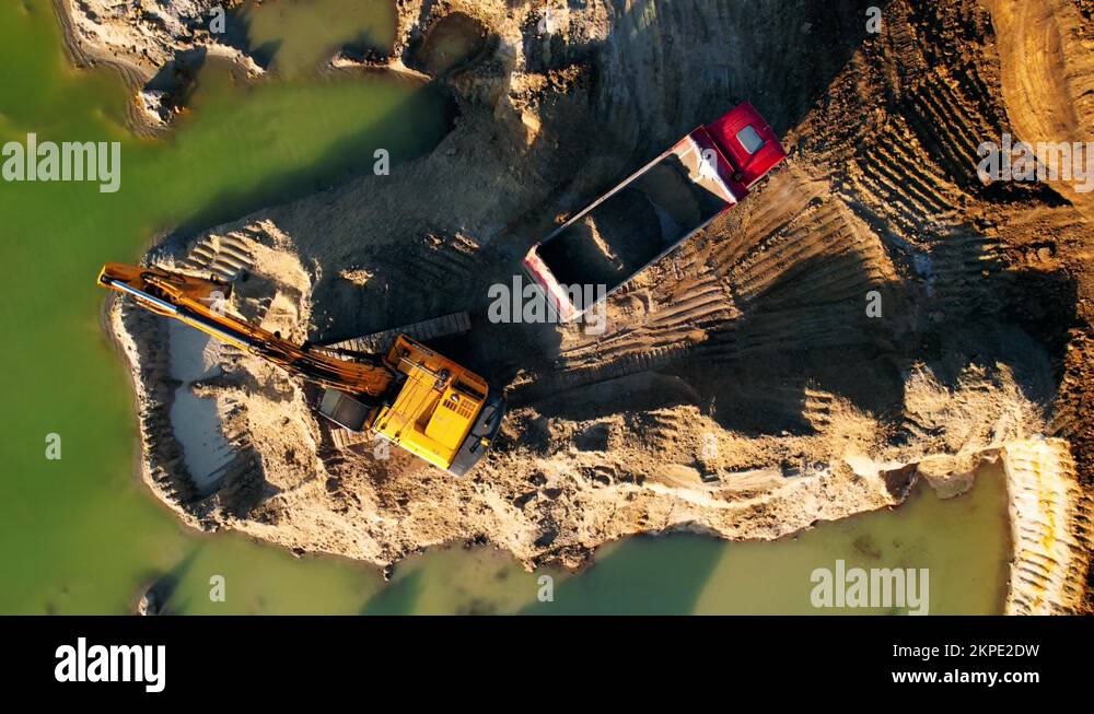 Mining excavator load the sand into dump truck on quarry. Loader ...