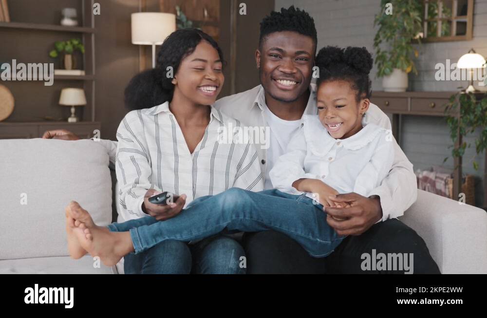 Carefree african american father, mather relaxing with biracial ...