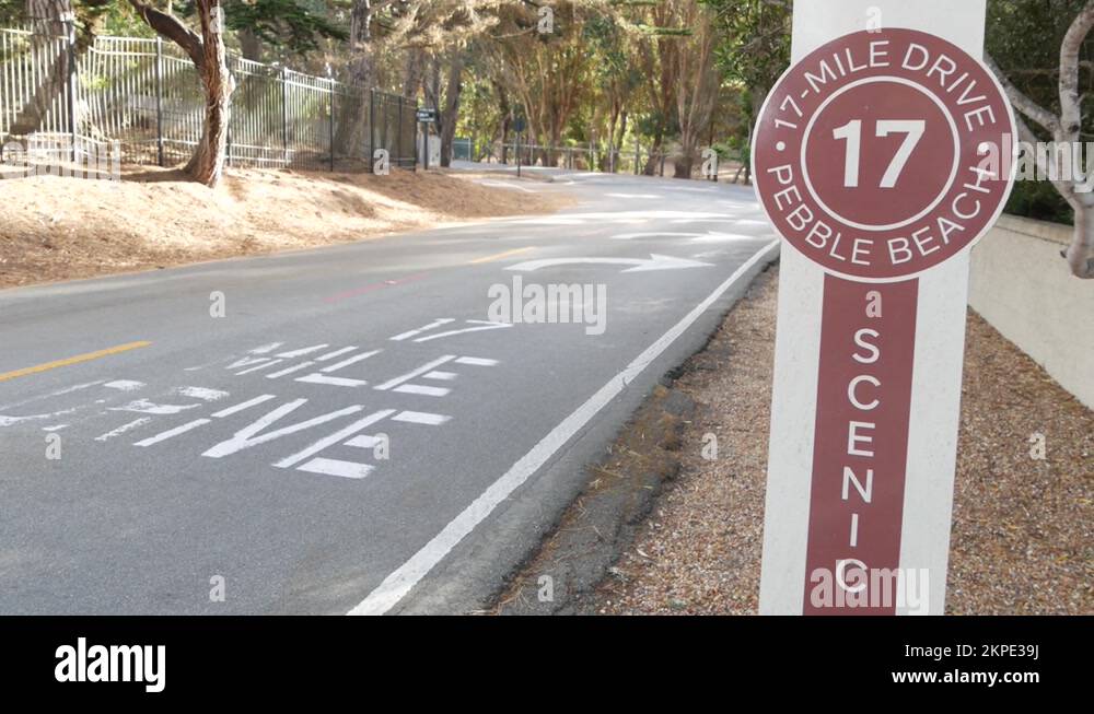 Scenic 17-mile drive, Monterey, California coast. Sign on asphalt, road ...
