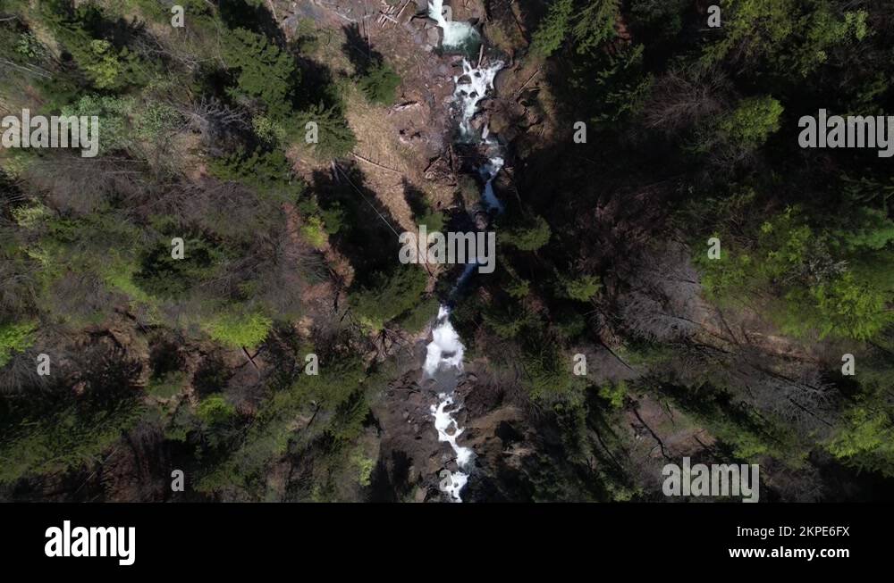Top down drone view of river in deep gorge and waterfall in Switzerland ...