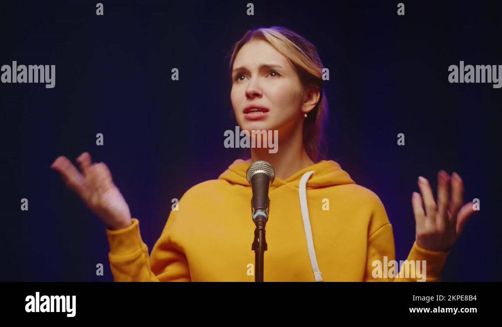 Stand-up cafe, woman comedy concert. Woman telling jokes on stage ...