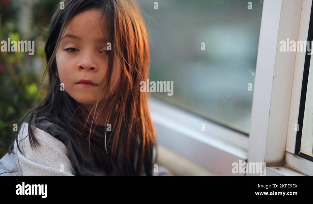 Little girl portrait staring out window Stock Video Footage - Alamy