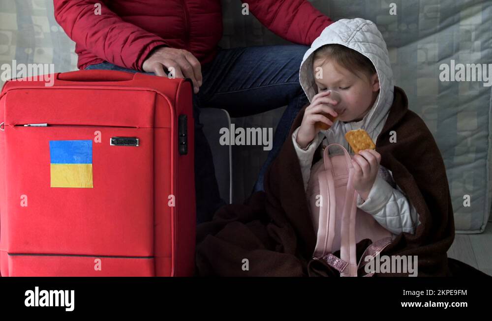 Refugees from Ukraine. An old man and his granddaughter are waiting for ...