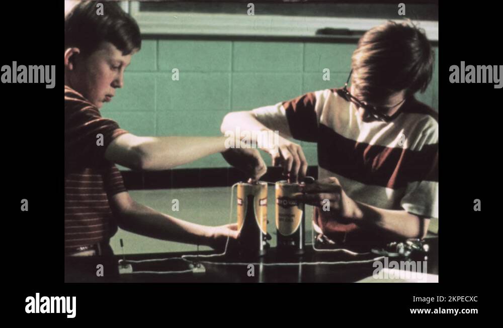1970s: boys work on physics project together in class. Boys create ...