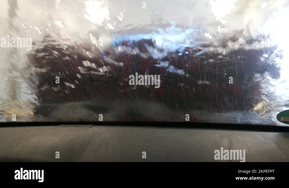 Washing the car in an automatic car wash, view of the inside of the car ...