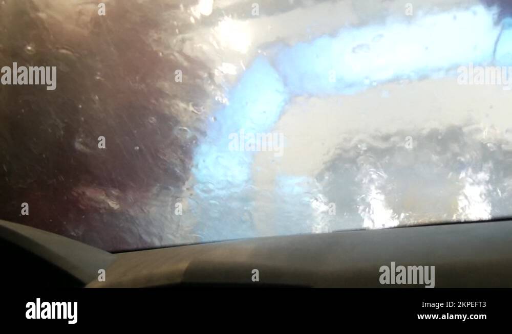 Washing the car in an automatic car wash, view of the inside of the car ...