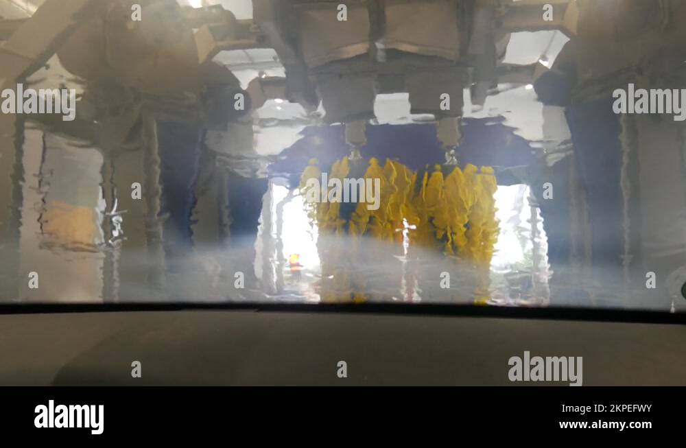 Washing the car in an automatic car wash, view of the inside of the car ...