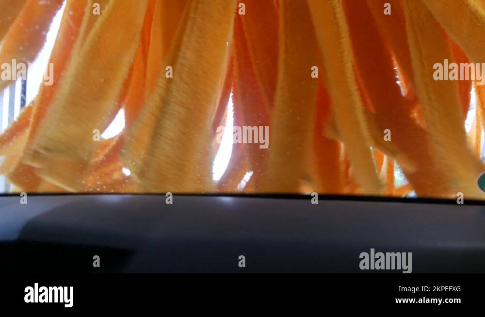 Washing the car in an automatic car wash, view of the inside of the car ...