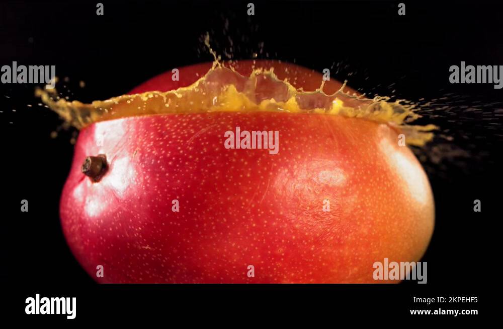Mango Slice falling and splashing on black background. Food levitation ...