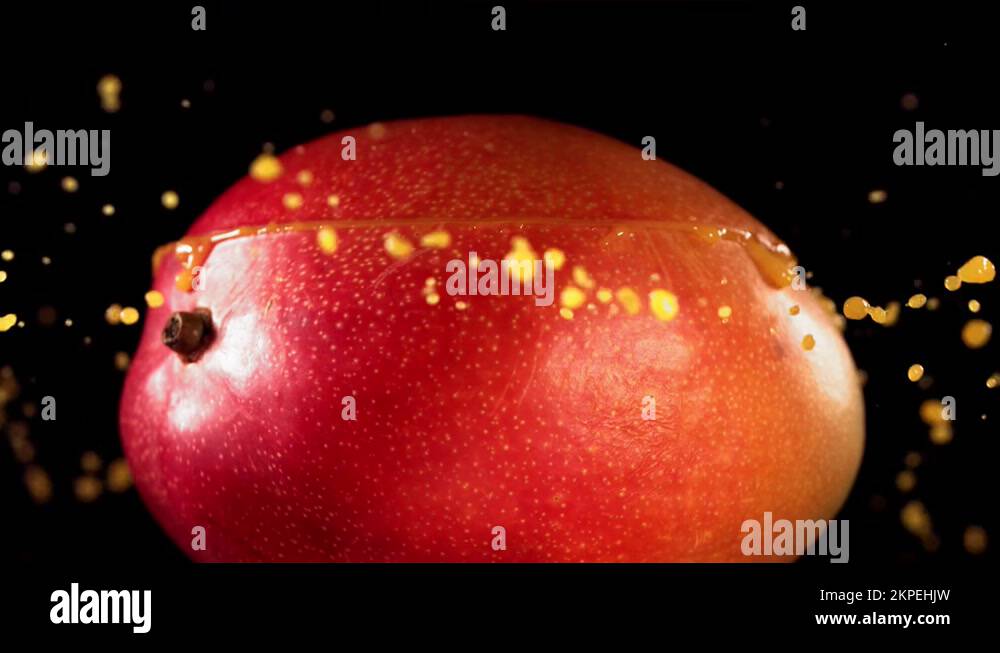 Mango Slice falling and splashing on black background. Food levitation ...