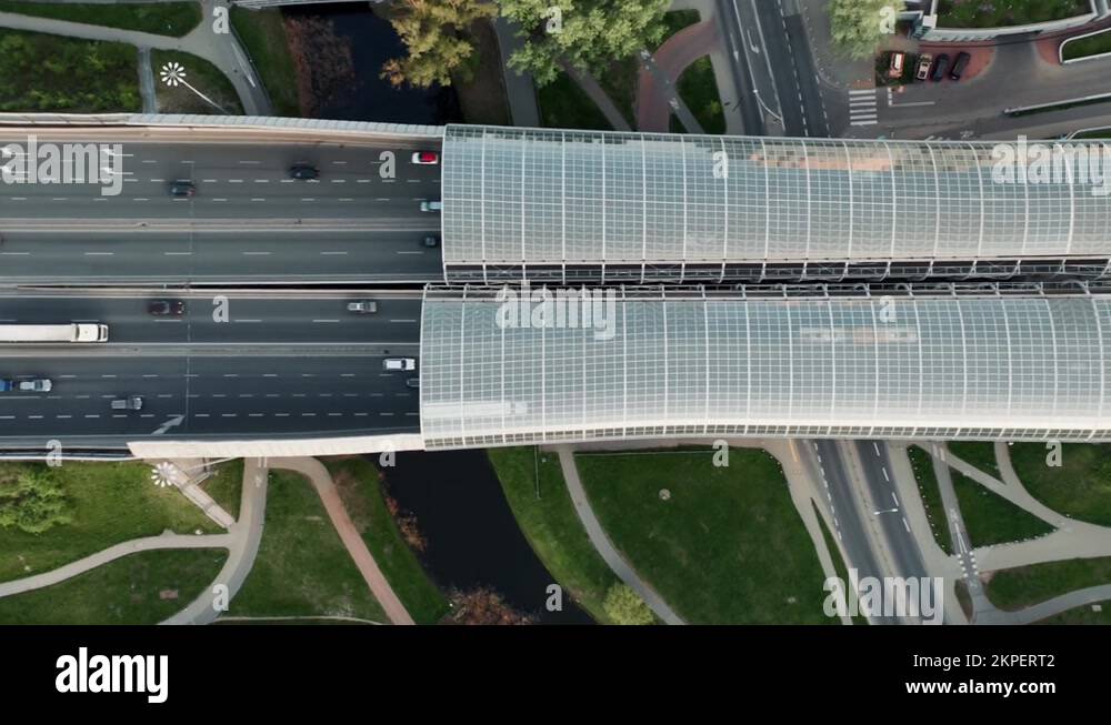 Aerial flyover traffic roadway intersection in city. Cars driving busy ...