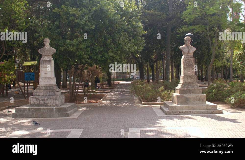 Monuments in city park sunlight. Busts famous people stand on pedestal ...