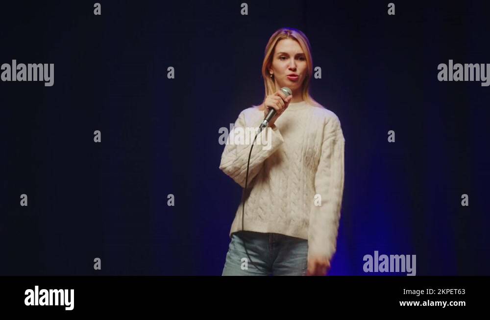 Stand-up cafe, woman comedy concert. Woman telling jokes on stage ...