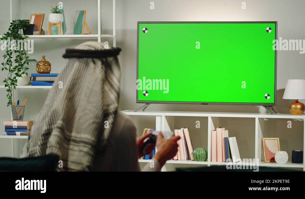 Middle eastern man playing video game, tv with chroma key. Television ...