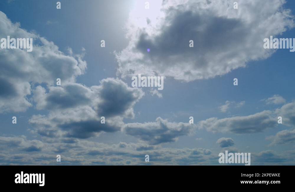 Clouds and sun rays in blue sky. Clouds with breathtaking sun rays view ...