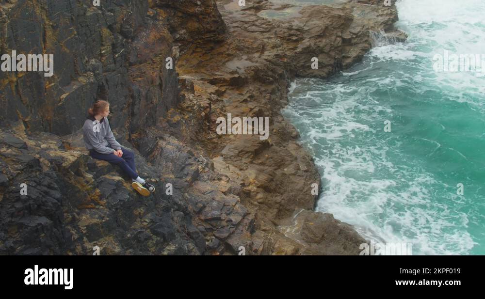 Lone man sitting edge cliff Stock Videos & Footage - HD and 4K Video ...
