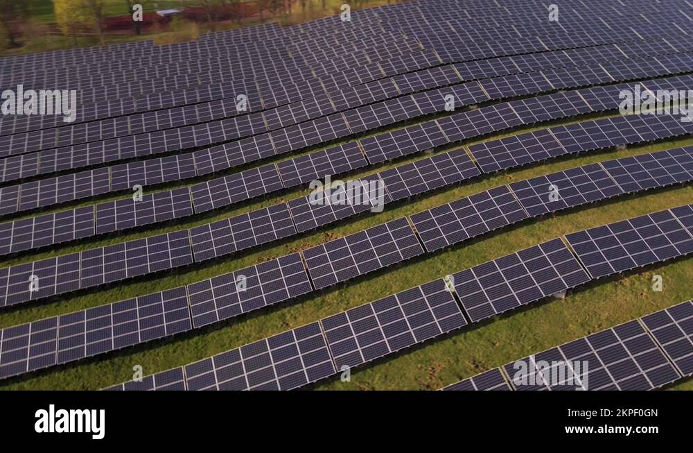A large solar farm at sunset in Europe. Fast aerial orbit shot Stock ...