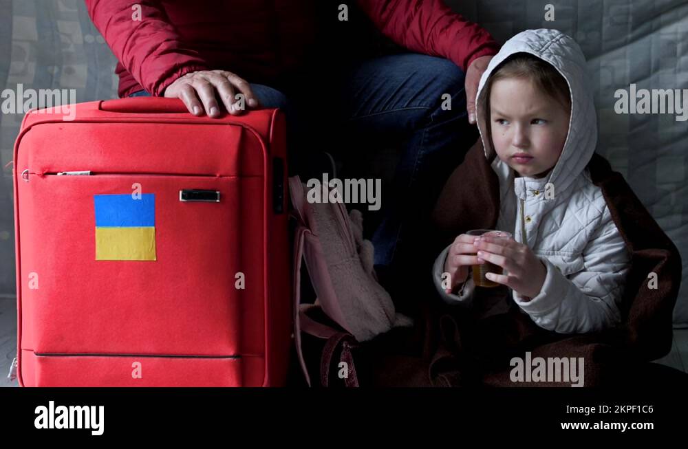 Refugees from Ukraine. An old man and his granddaughter are waiting for ...