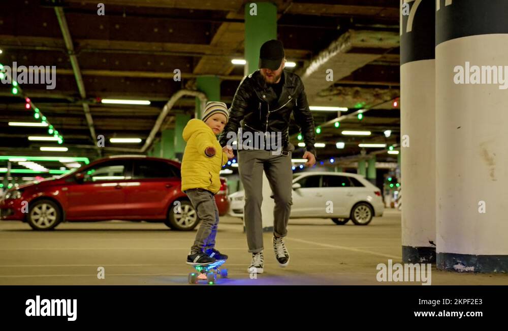 Happy father and son family, father teaches young son to ride glowing ...