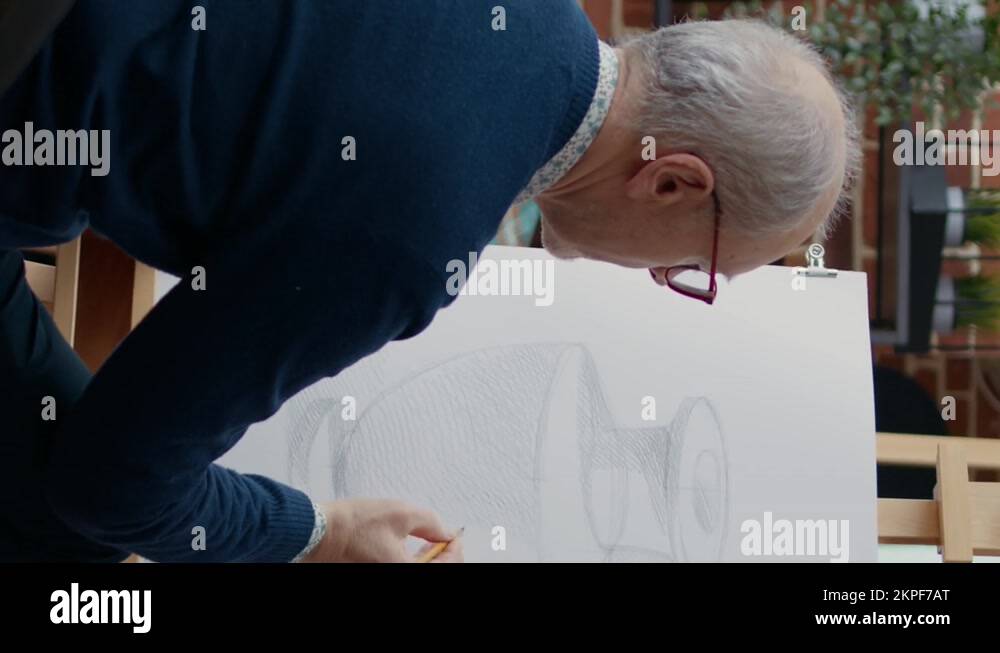 Vertical video: Elder student drawing vase model on canvas in art class ...
