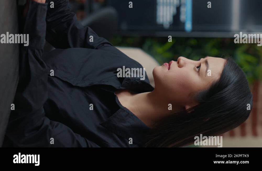 Vertical video Portrait of smiling asian programer focused on writing ... Vertical video Portrait of smiling asian programer focused on writing ...