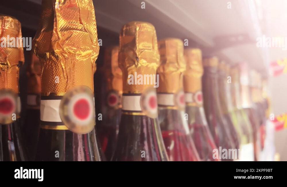 Champagne bottles line up in a liquor store, ABC store, or supermarket ...