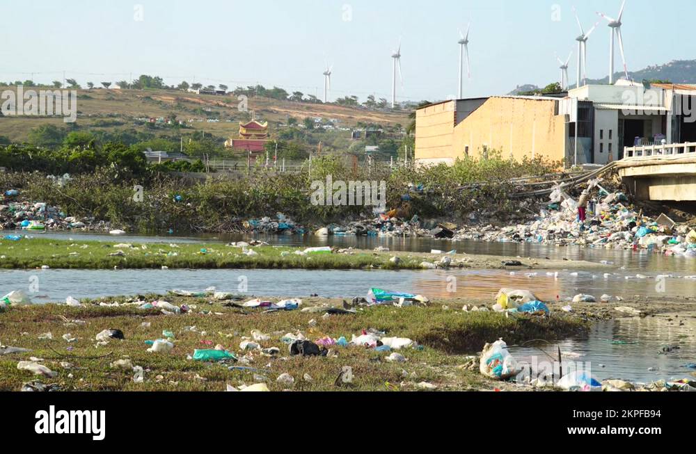 Juxtaposition of green energy production (wind turbines) and polluted ...