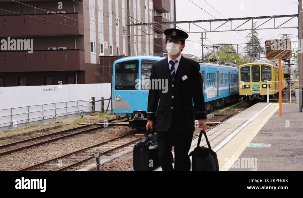 Japanese Train Conductor Walking on Platform as Trains Arrive Stock ...